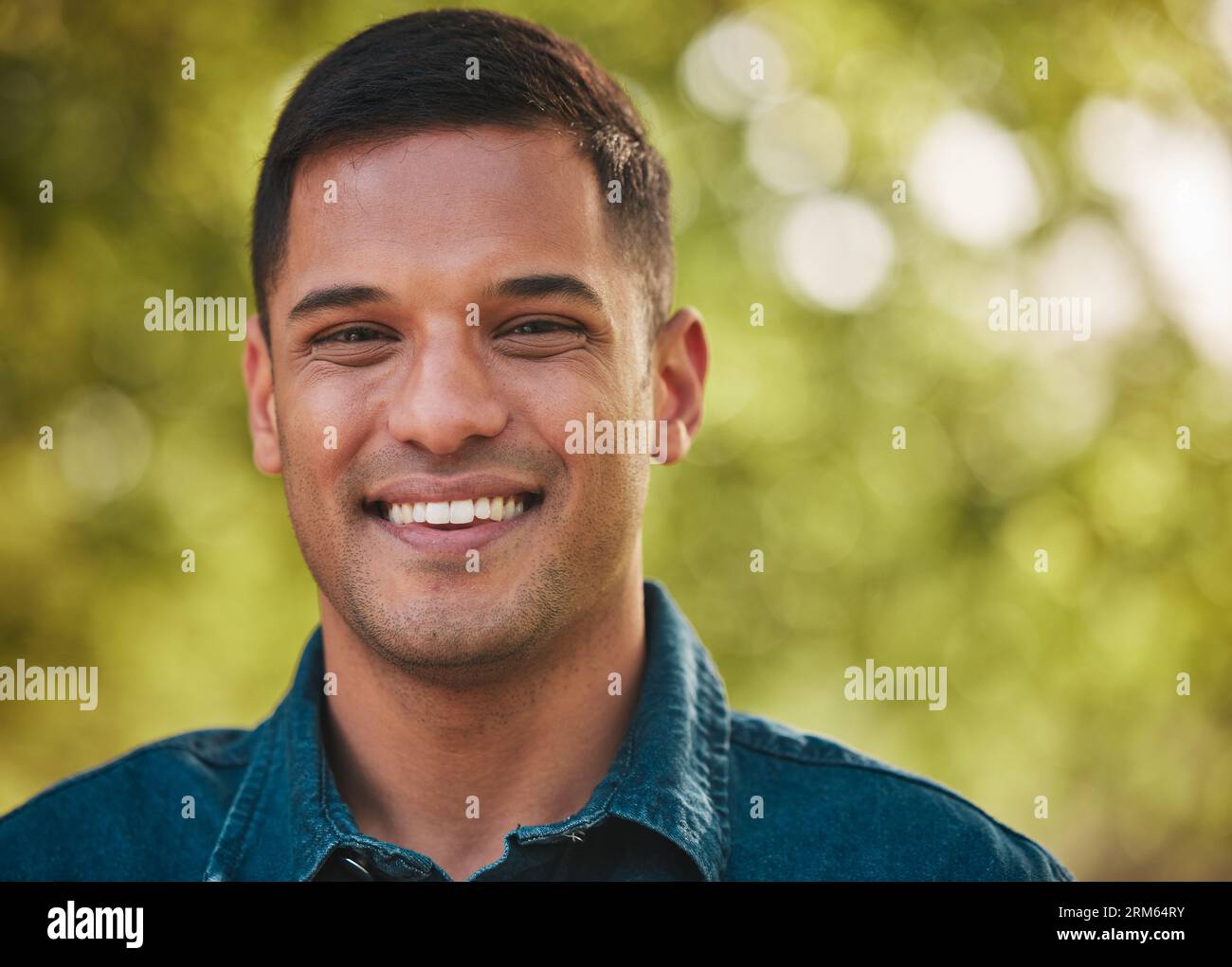 Face, smile and man in nature outdoor on vacation, holiday or travel at ...