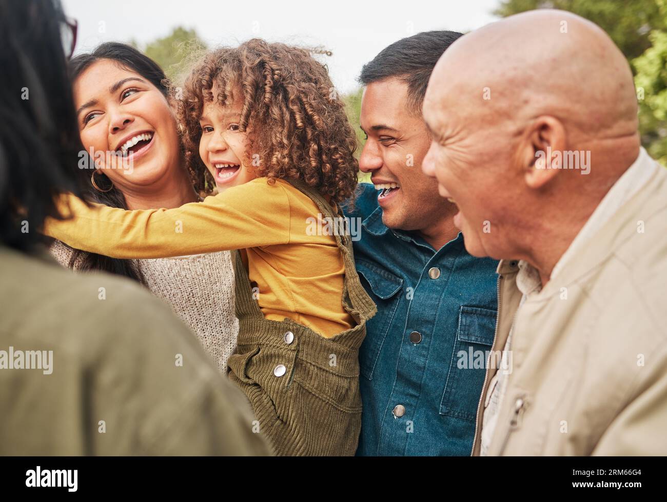 Happy family, grandparents and parents playing with kid in a park ...