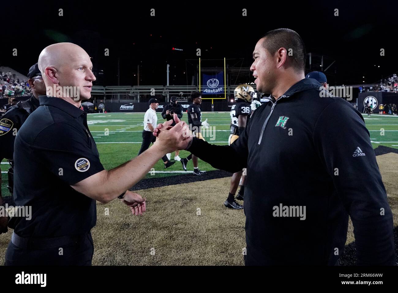 Vanderbilt coach Clark Lea, left, and Hawaii coach Timmy Chang meet at ...
