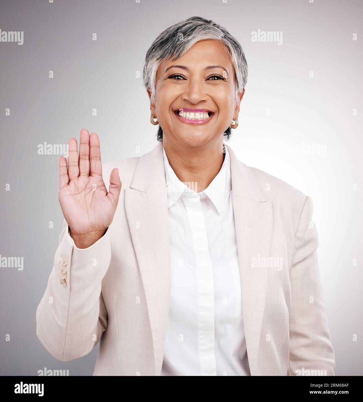 Portrait, business and a studio wave from a woman for hello, welcome or ...