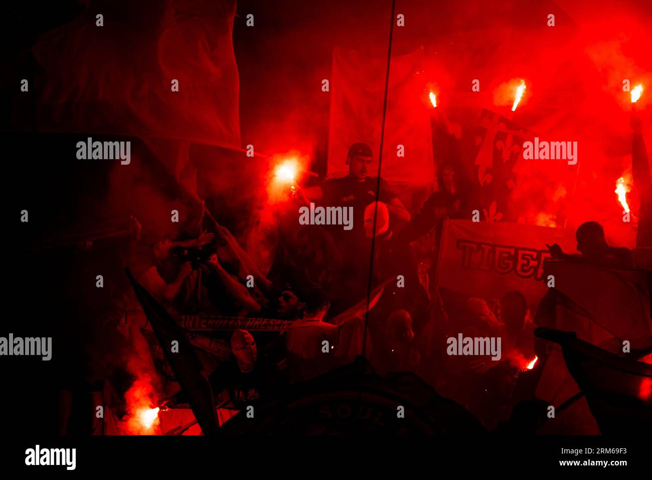 Paris, France. 26th Aug, 2023. RC LENS Ultra fans light flares and hold ...