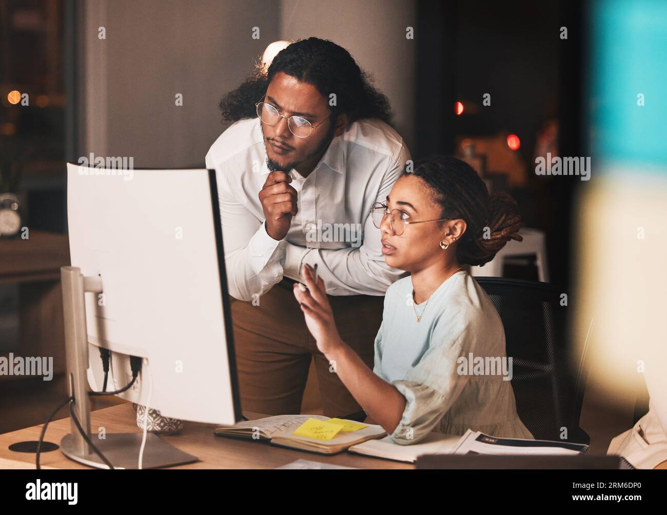 Meeting, late night and team at computer with problem solving, ideas ...