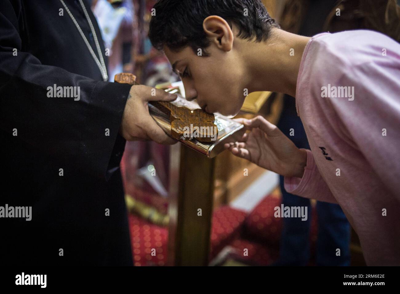A Coptic Christian kisses the cross when he attends the Coptic ...