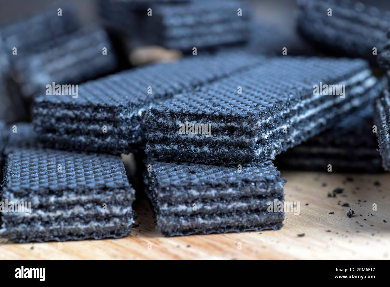 Crispy black waffles with cream filling, close-up of sweet black ...
