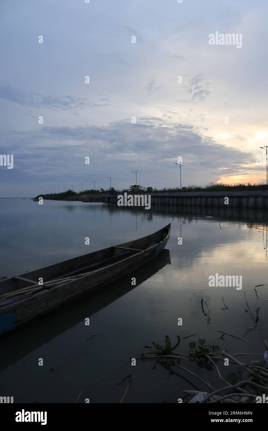 Traditional wooden boat floating on the waters of Lake Limboto ...