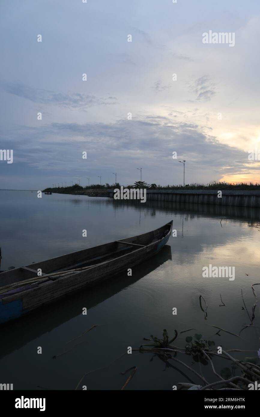Traditional wooden boat floating on the waters of Lake Limboto ...