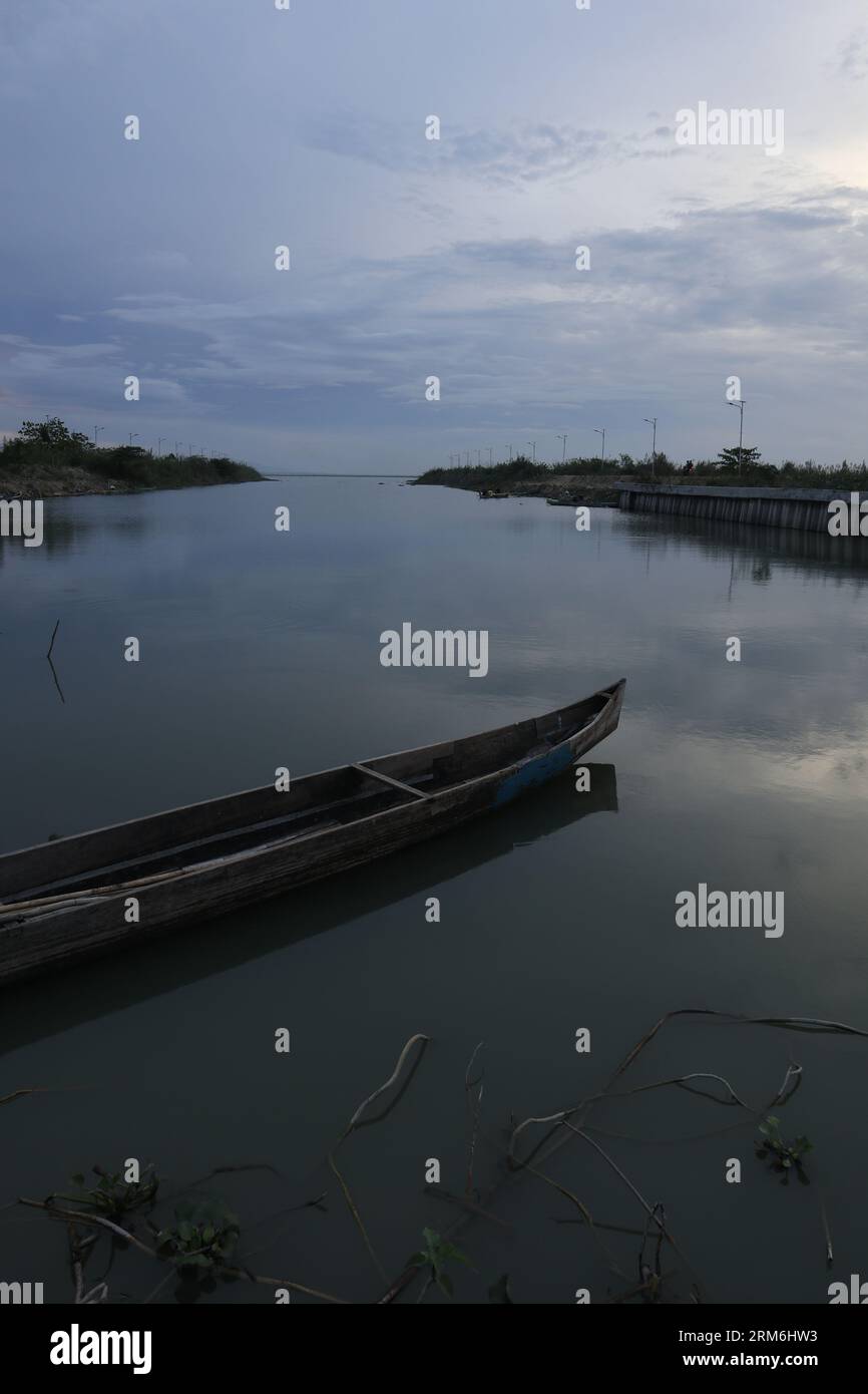 Traditional wooden boat floating on the waters of Lake Limboto ...