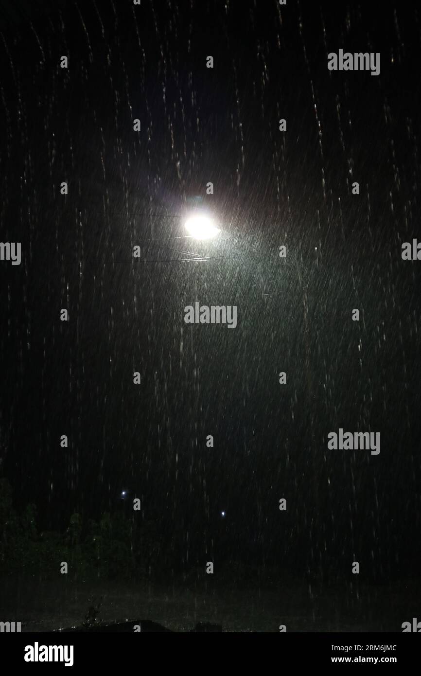 rain at night. Dark background shot of rain falling Stock Photo - Alamy