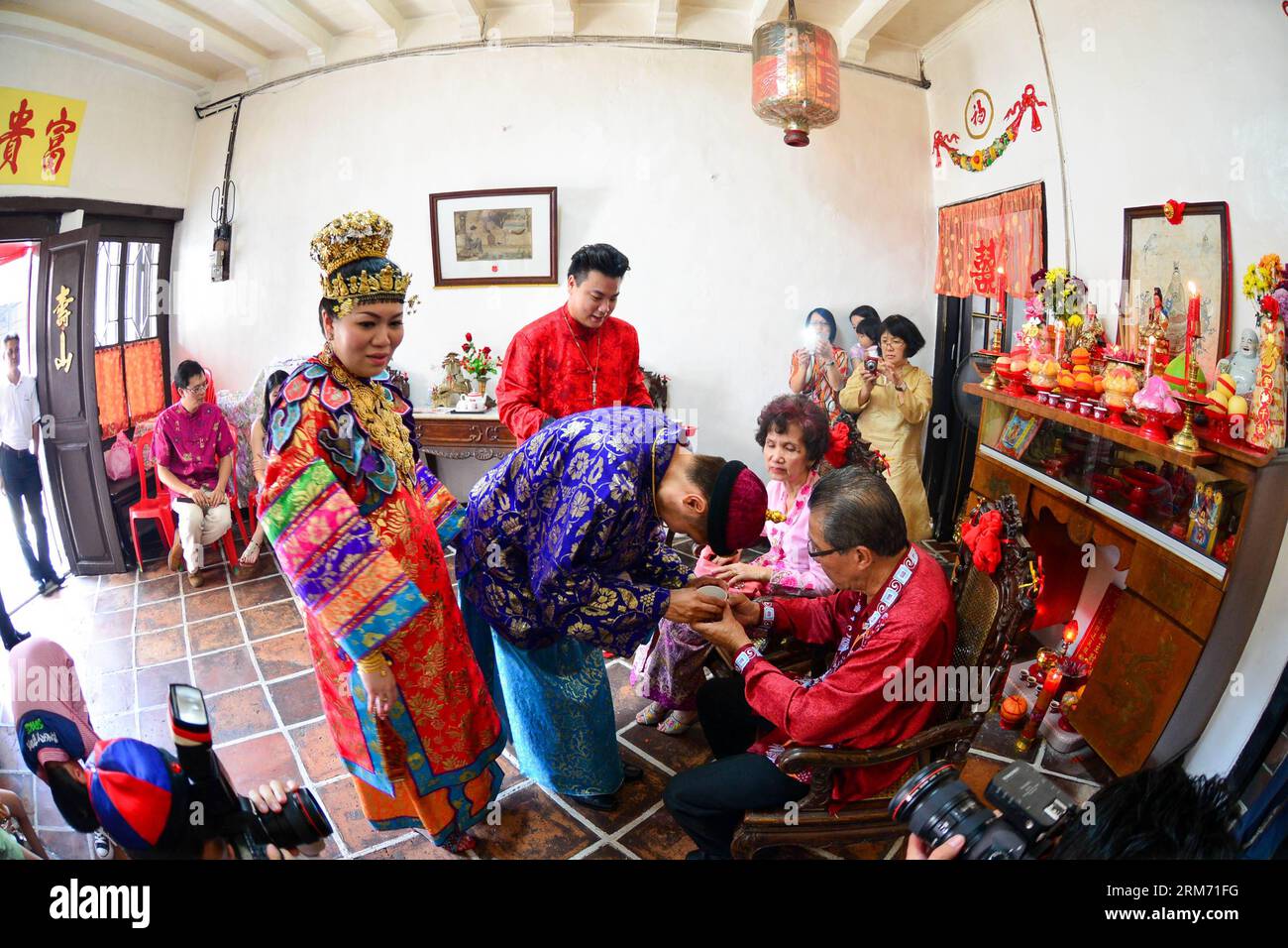 The bride and the groom serve tea to their parents during their Baba ...