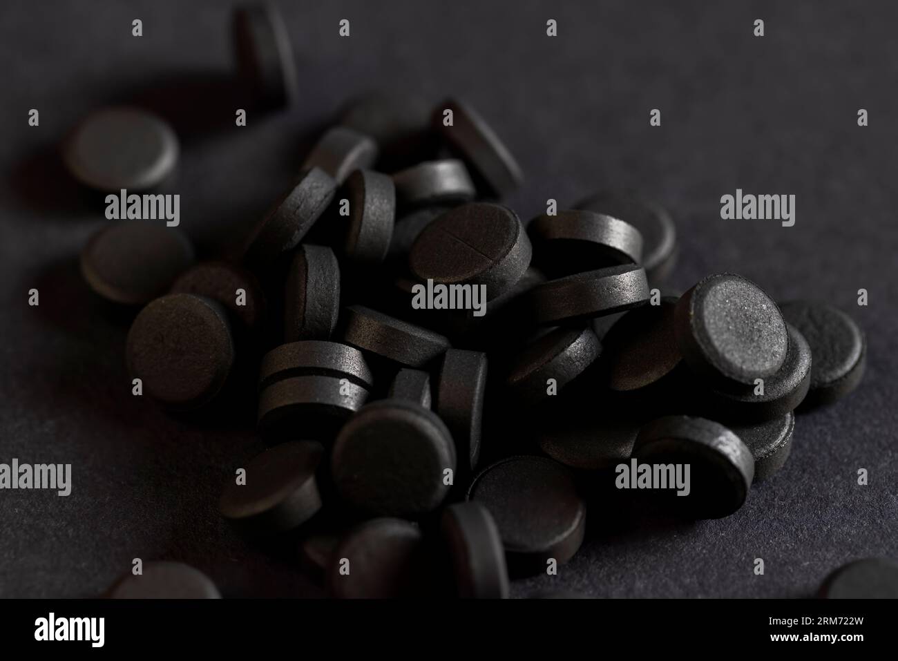 Open and unpacked tablets of black color close-up, several of the same ...