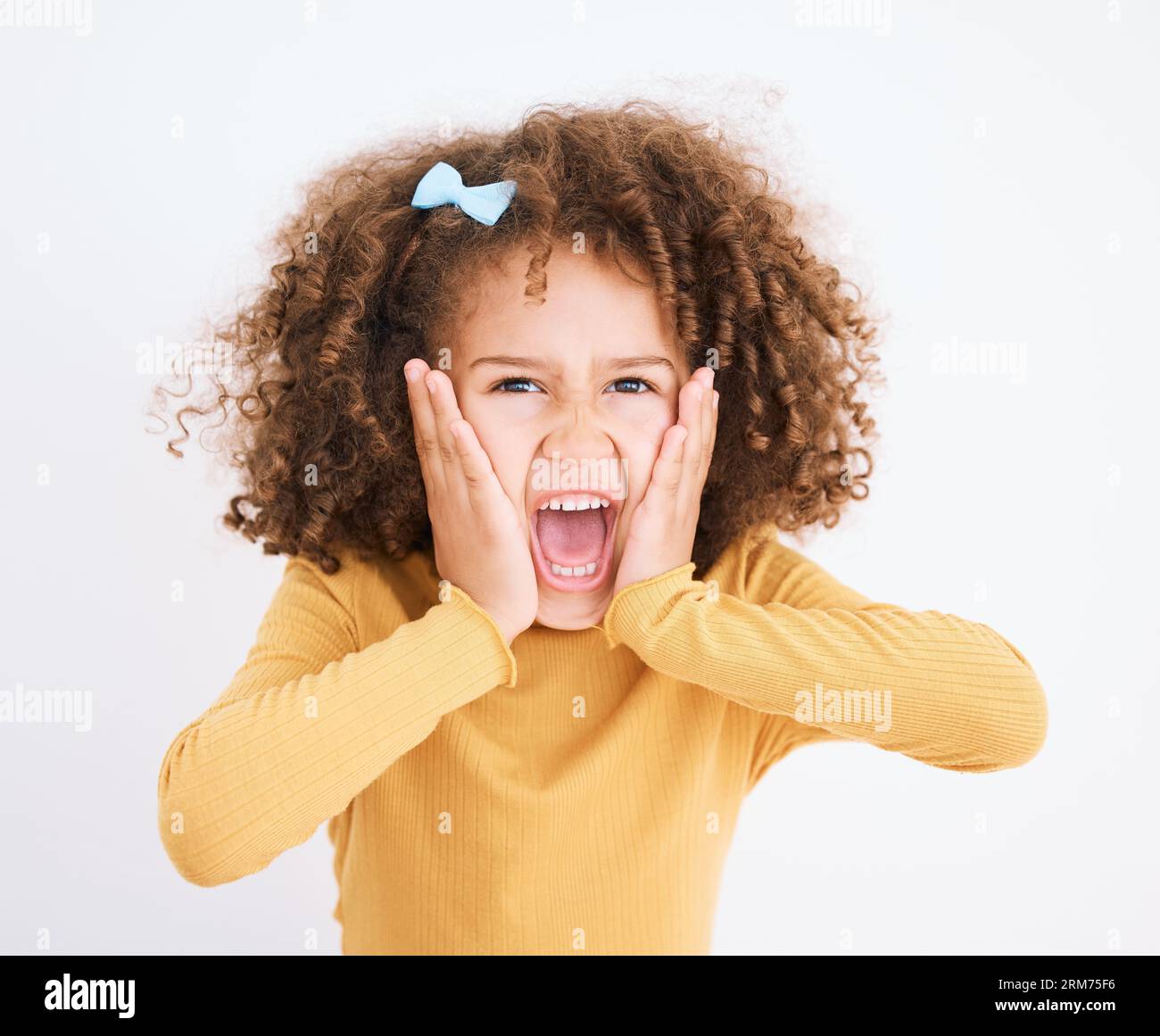 Child, hands on face and scream in studio for fear, bad news or ...