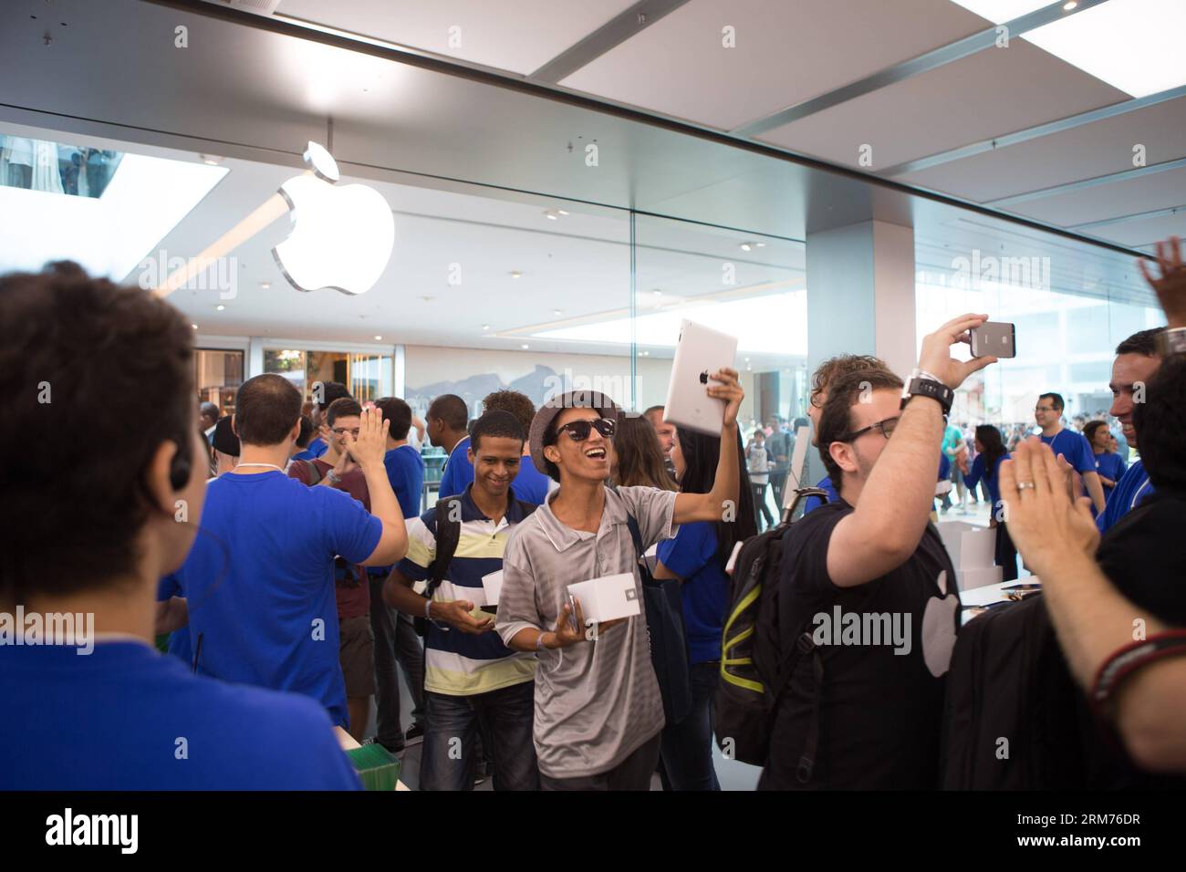 Customers are seen in a newly opened apple store in a Village Mall of ...