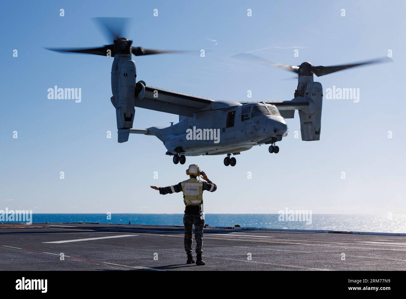 Royal Australian Navy sailor Leading Seaman Jayden Goodes guides a U.S ...