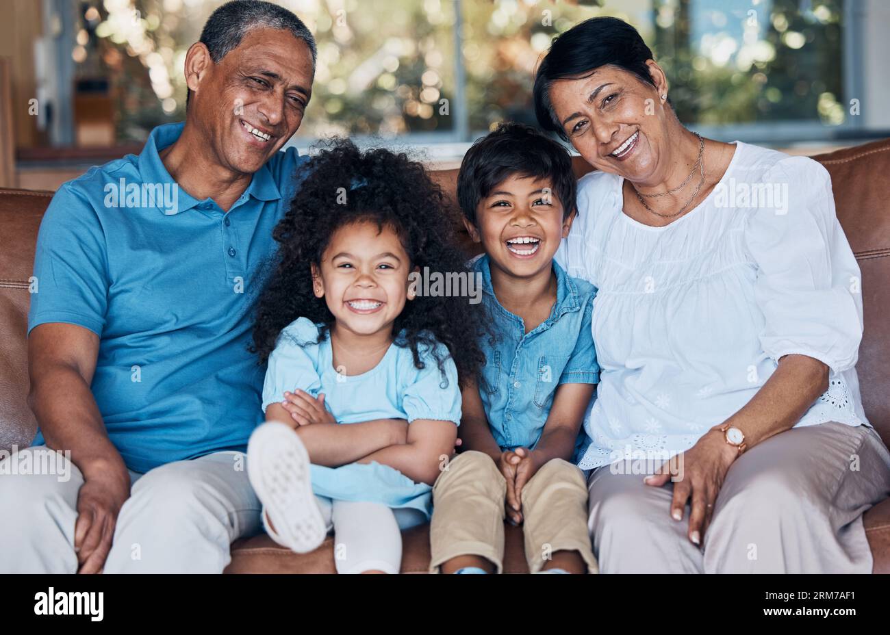Happy, portrait and grandparents with children on sofa for smile ...