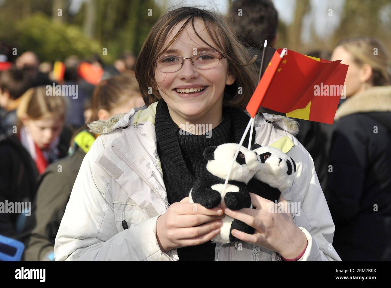 A girl holding the Chinese national flags and panda toys wait for the ...