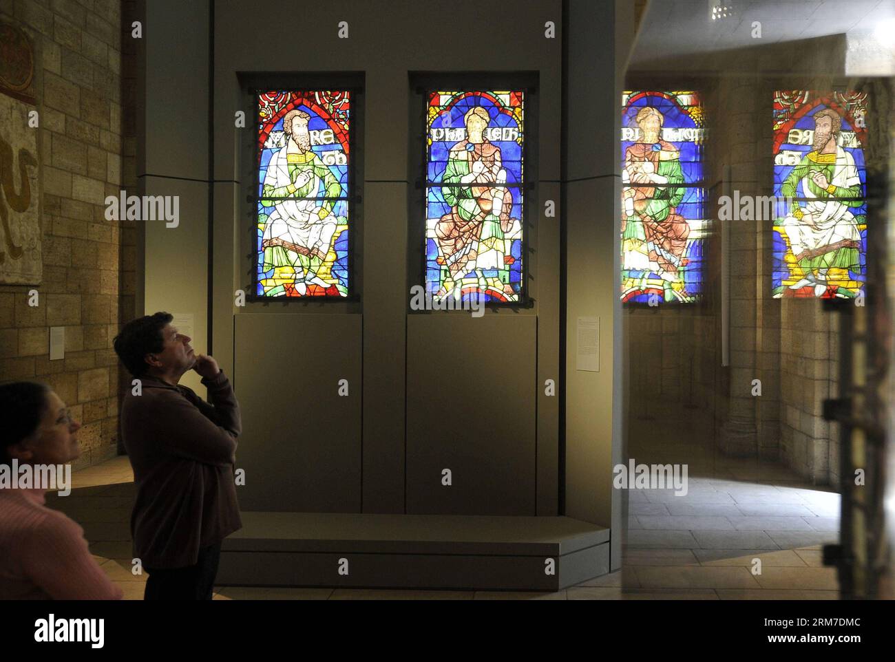 Visitors view objects exhibited at the Cloisters Museum in New York ...