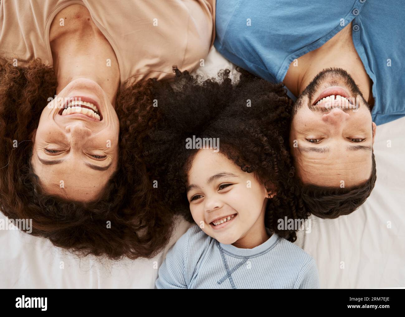 Bedroom top view, child and parents laugh, connect and enjoy quality ...