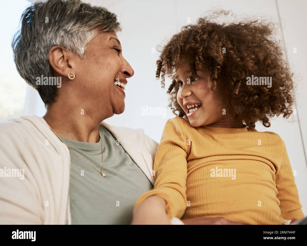 Grandmother, kid and funny laugh in home, bonding for connection and ...