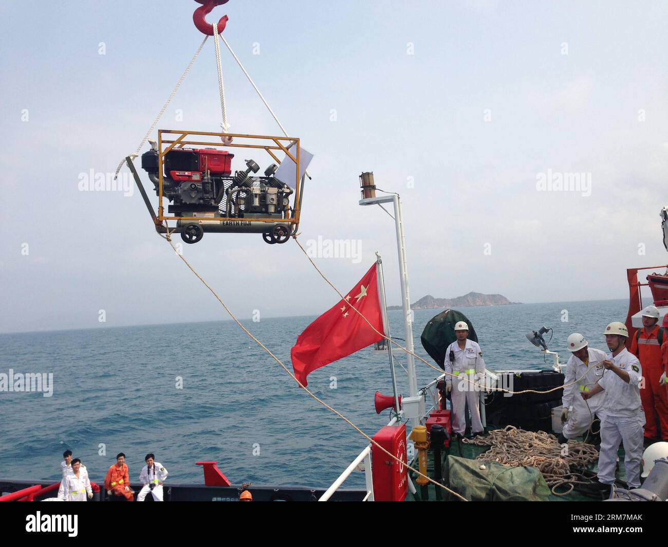 Members of a Chinese emergency response team ship the rescue vessel ...
