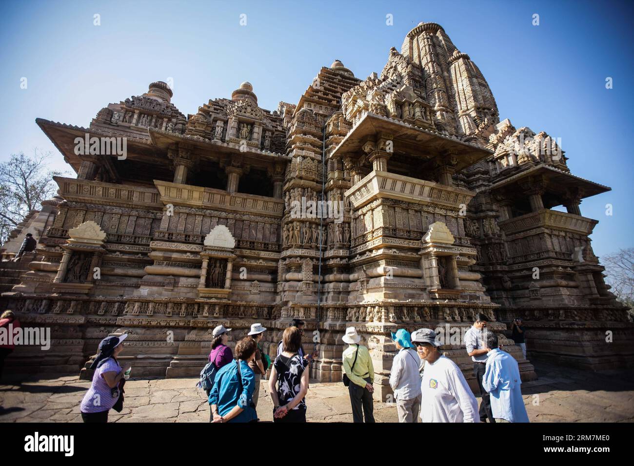 Tourists visit the Khajuraho group of monuments in Madhya Pradesh of ...
