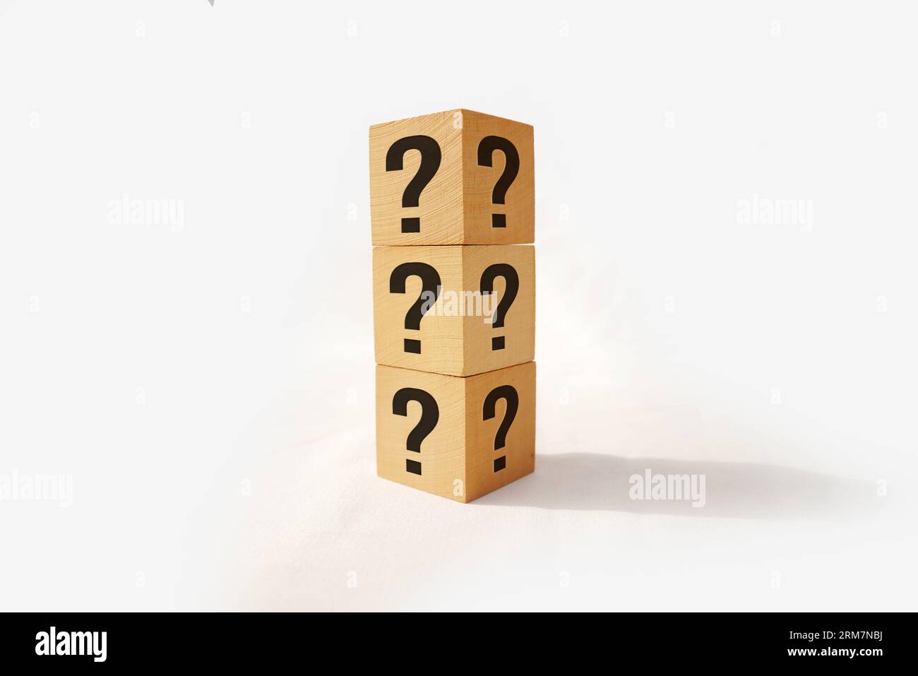 Stack of three wooden cubes with question mark over nature background ...