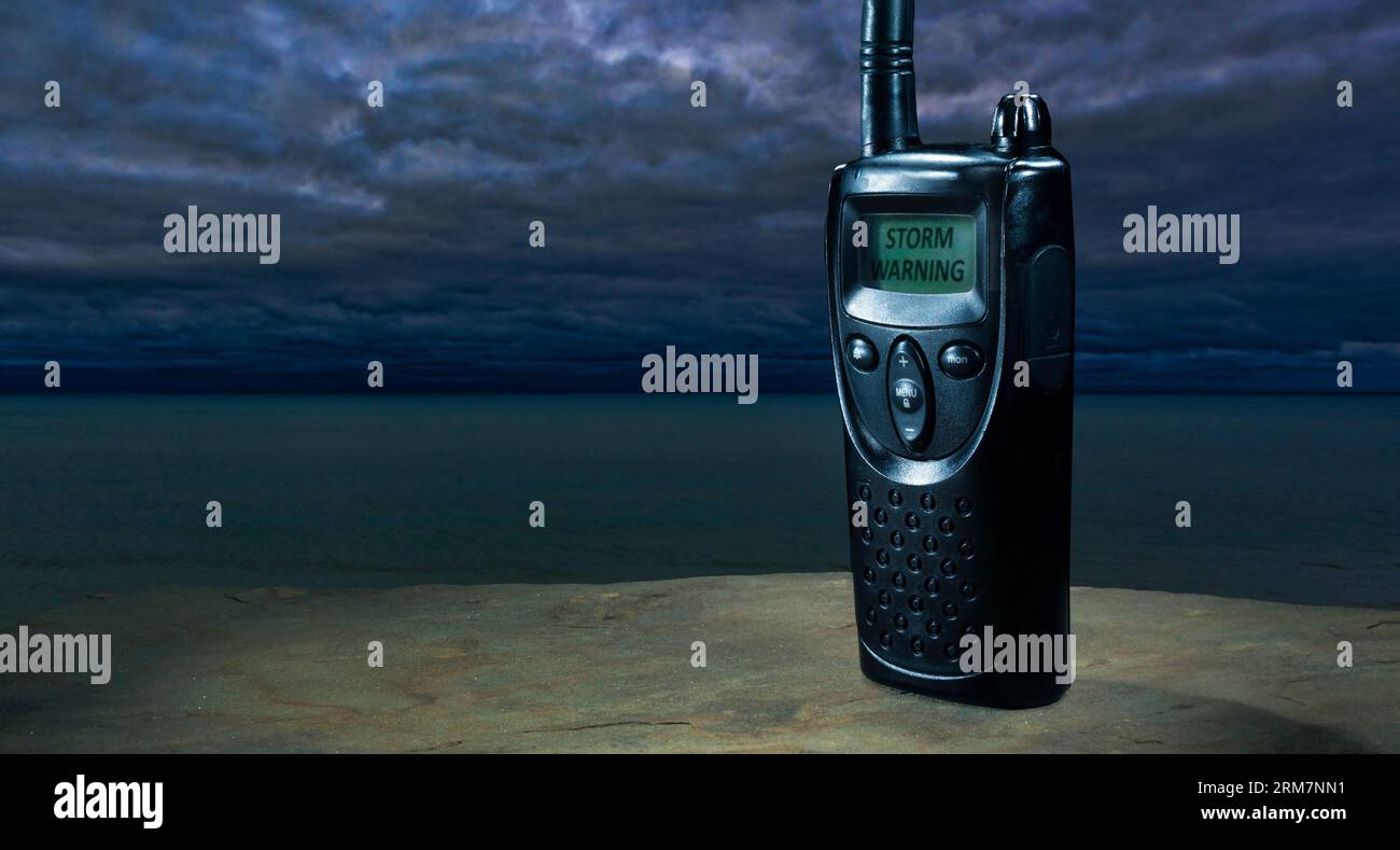Handheld transceiver with a storm warning flashing across the screen ...