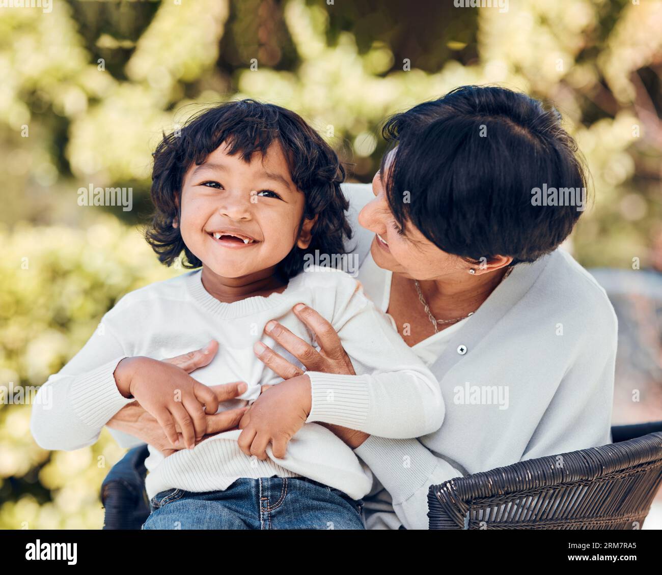 Boy, hug and mature woman in park for bonding, support and summer break ...