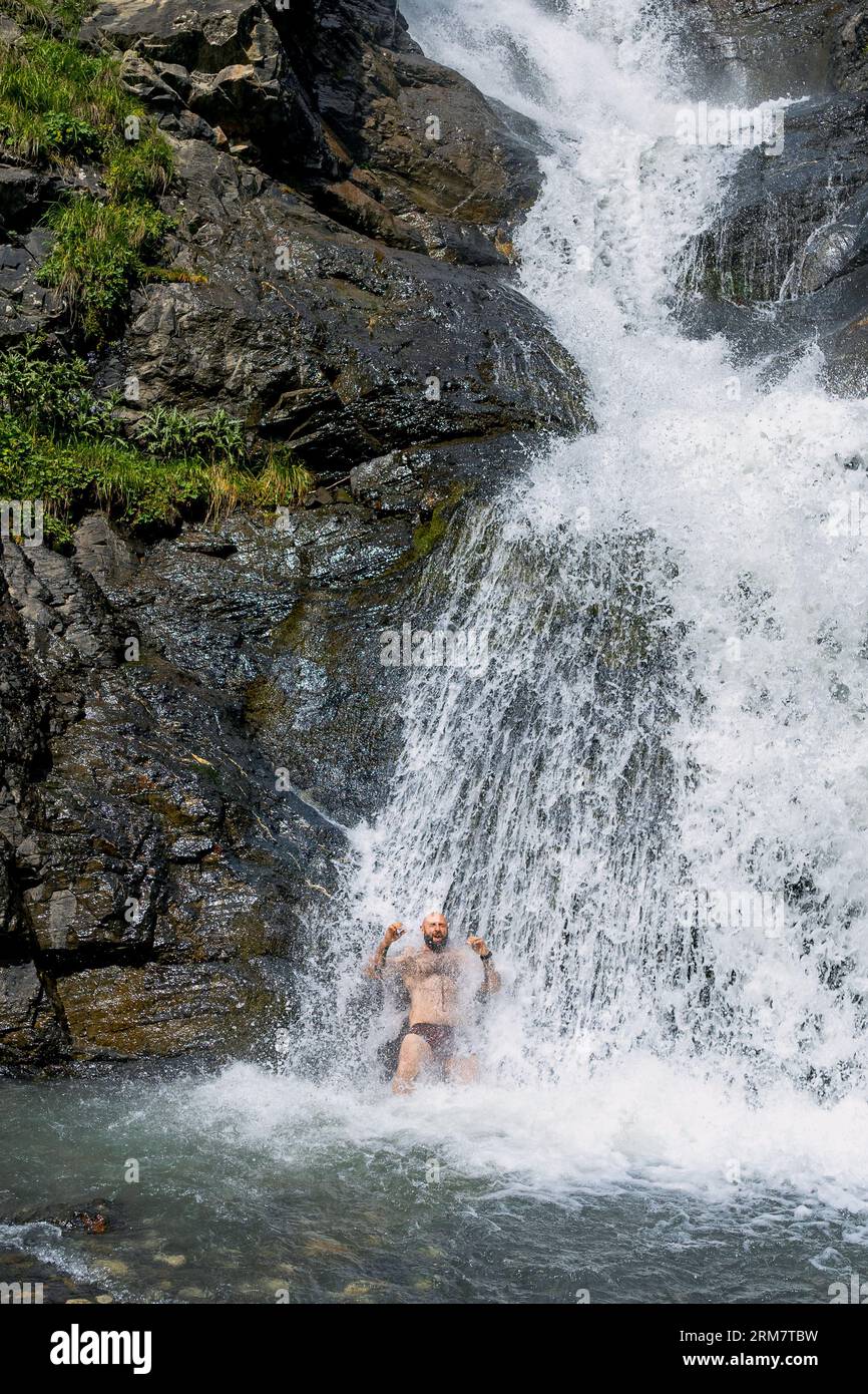 Man standing under waterfall hi-res stock photography and images - Alamy