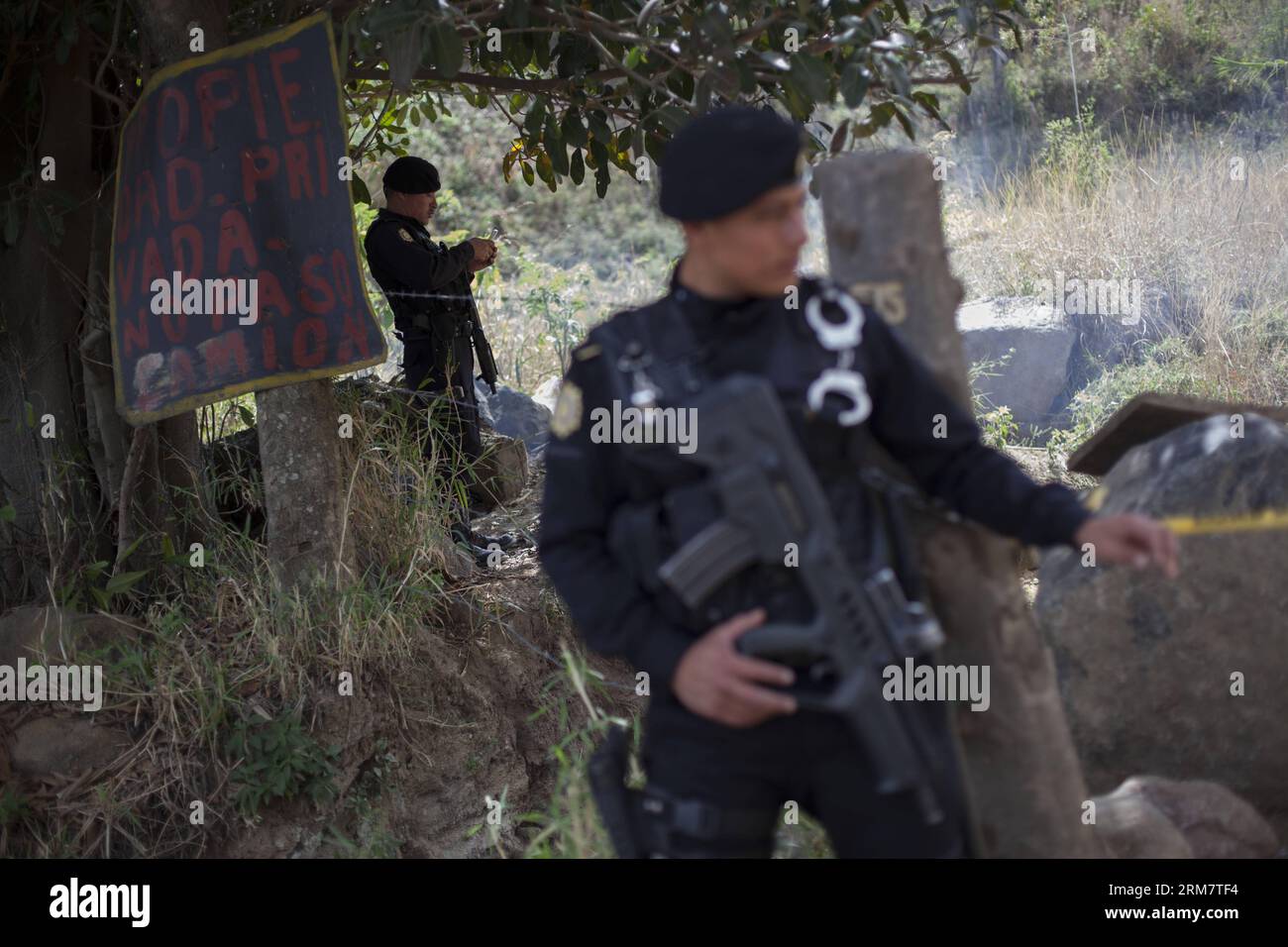 Guatemalan National Police Special Forces agents stand guard in front ...