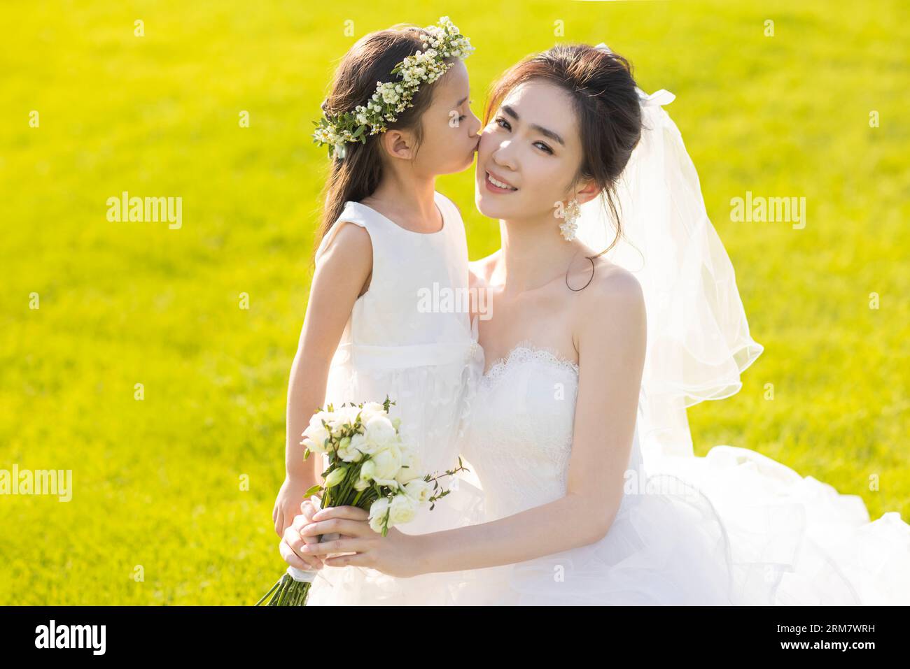 Beautiful bride with flower girl Stock Photo - Alamy