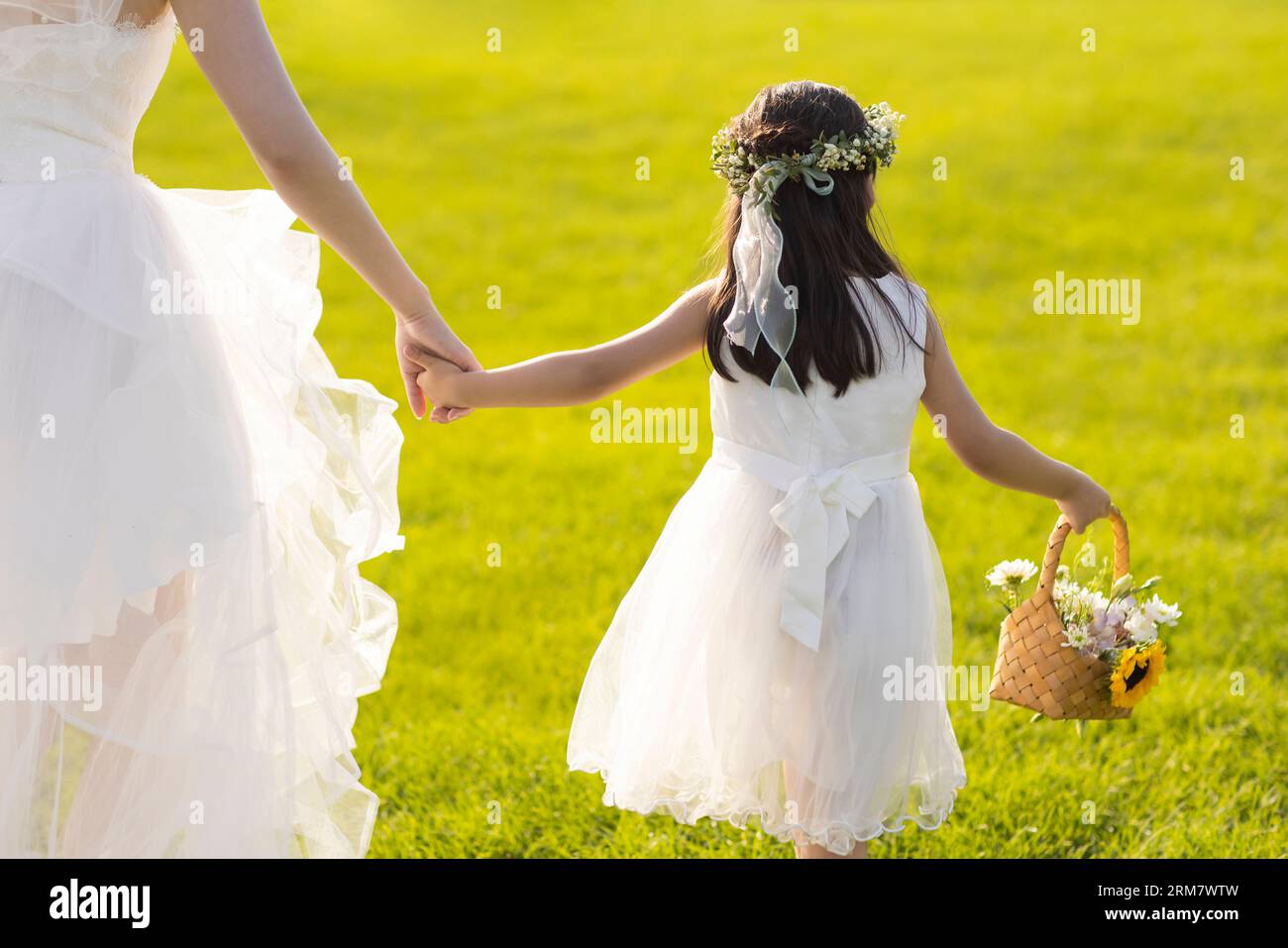 Beautiful bride with flower girl Stock Photo - Alamy