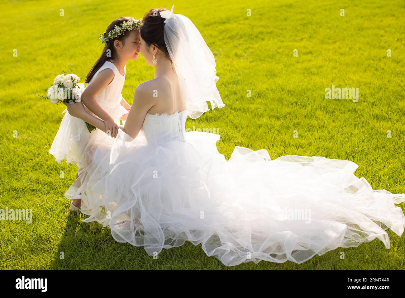 Beautiful bride with flower girl Stock Photo - Alamy