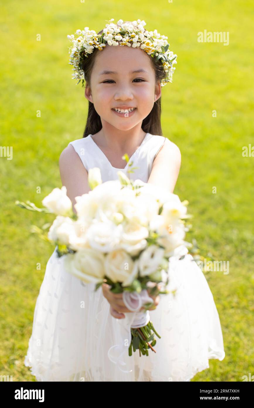 Girl standing holding bouquet hi-res stock photography and images - Alamy