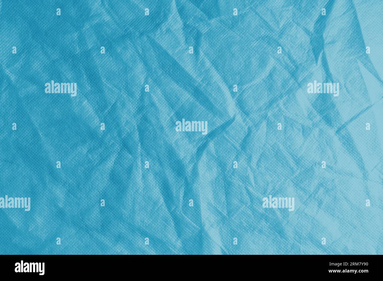 Wrinkled, crumpled blue fabric texture background. Wrinkled and creased ...