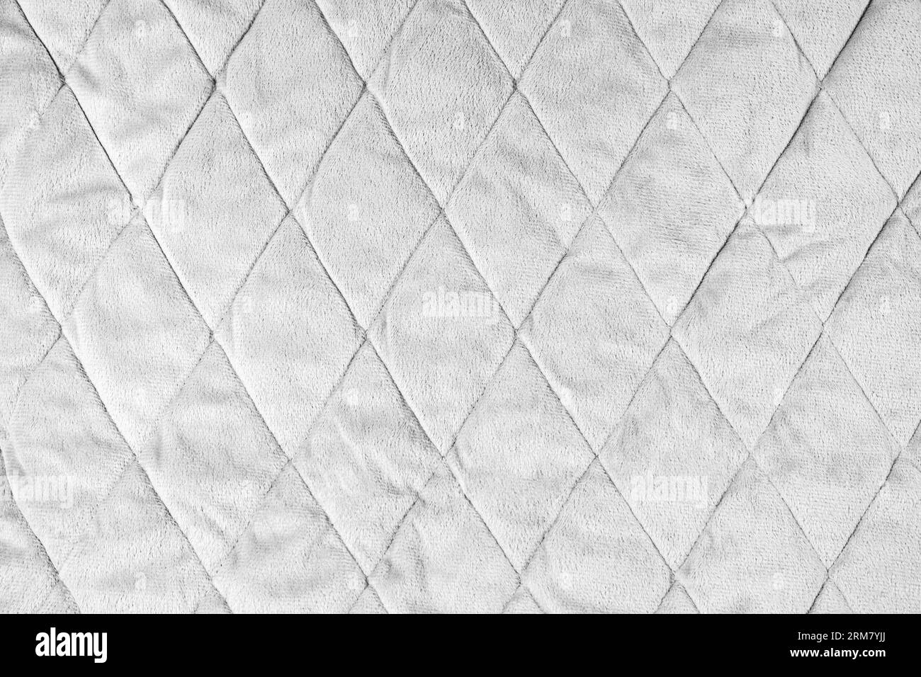 Quilted velours fabric background. White texture blanket or puffer ...