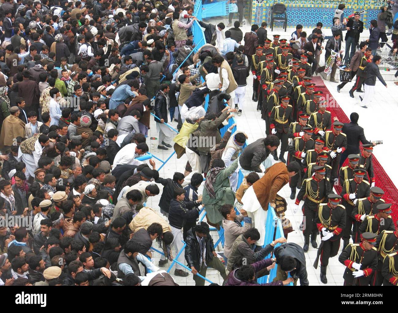 Afghans gather around the holy mace in front the Hazrat-e-Ali shrine ...