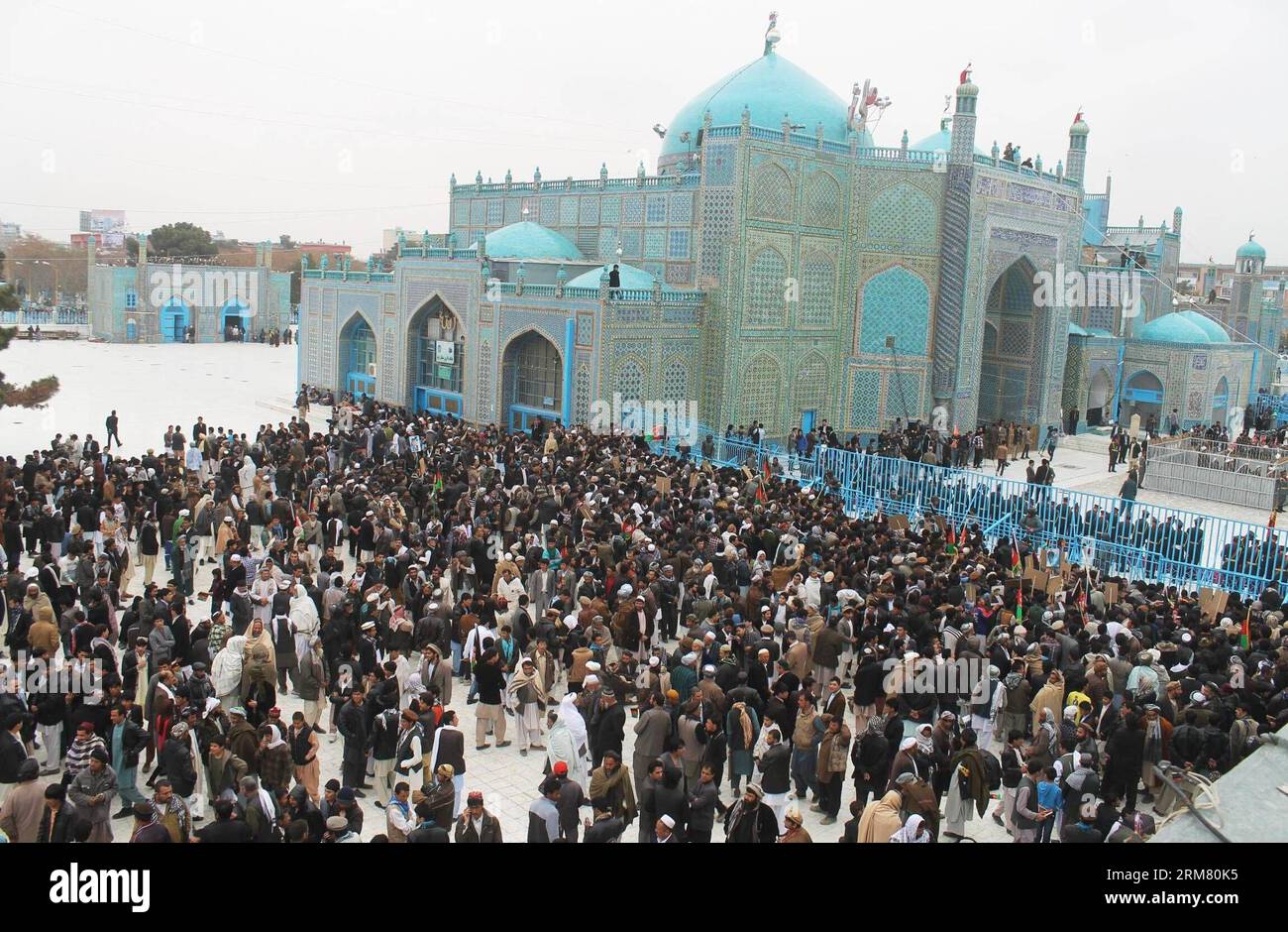 Afghans gather around the holy mace in front the Hazrat-e-Ali shrine ...