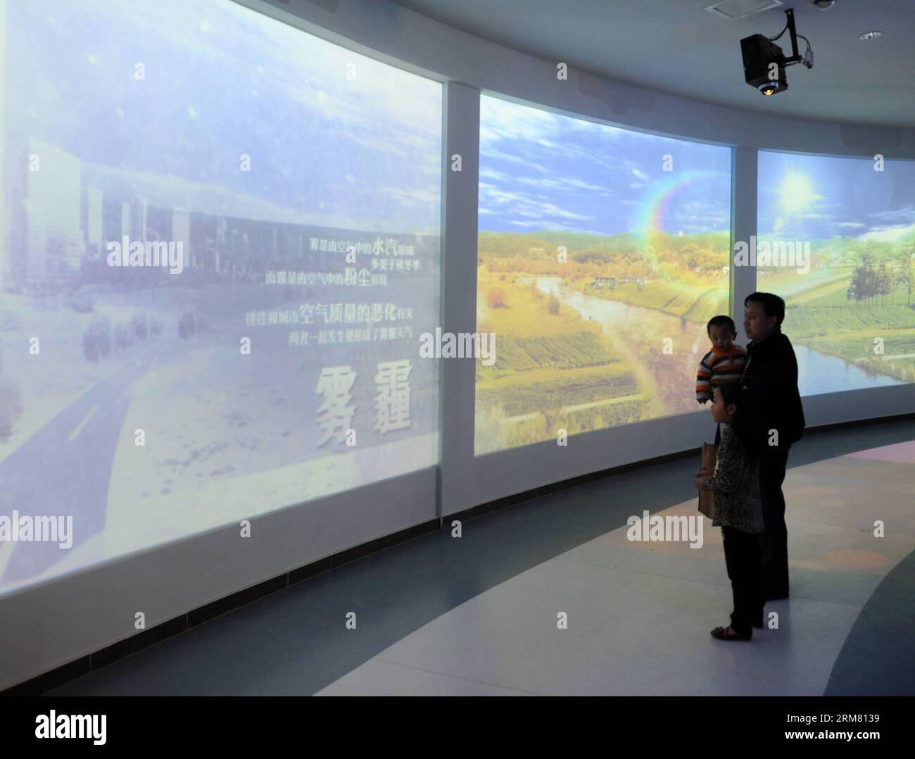 A resident carries a child as they learn about meteorological knowledge ...