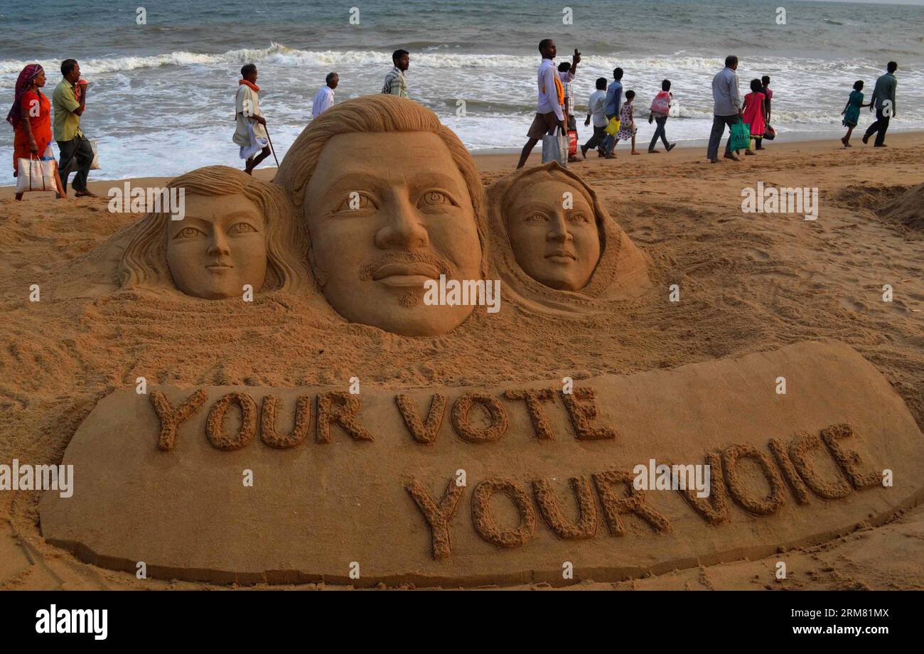 PURI, March 23, 2014 (Xinhua) -- People walk past an election campaign ...
