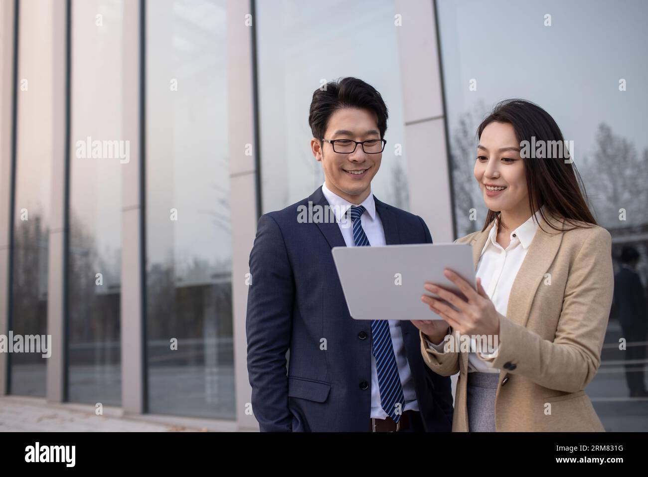 Confident Chinese business people talking outdoors Stock Photo - Alamy