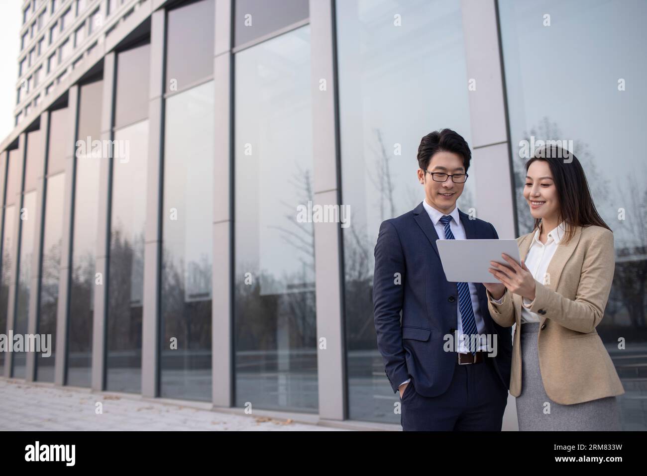 Confident Chinese business people talking outdoors Stock Photo - Alamy