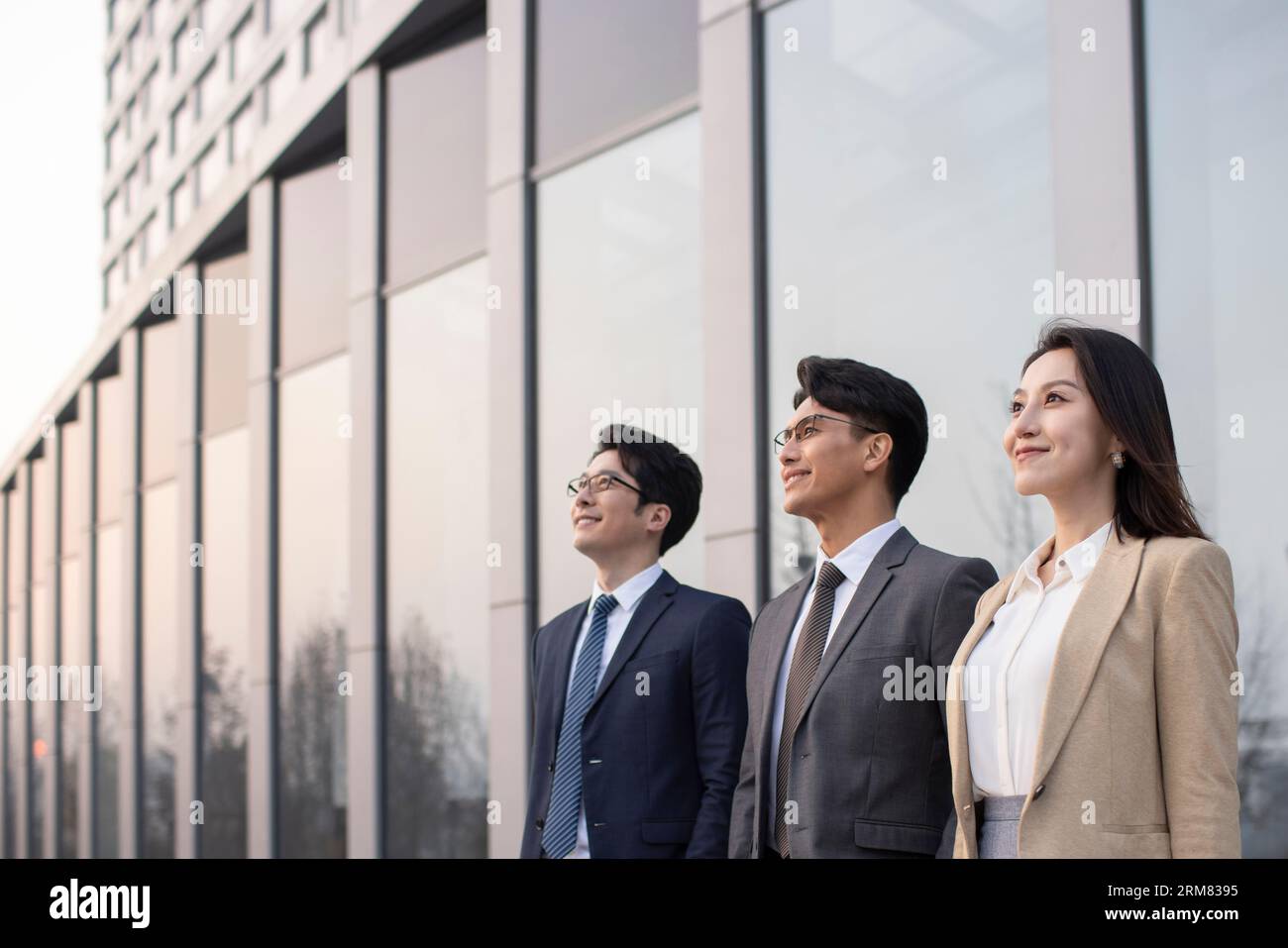Leadership standing side by side smiling looking away hi-res stock ...