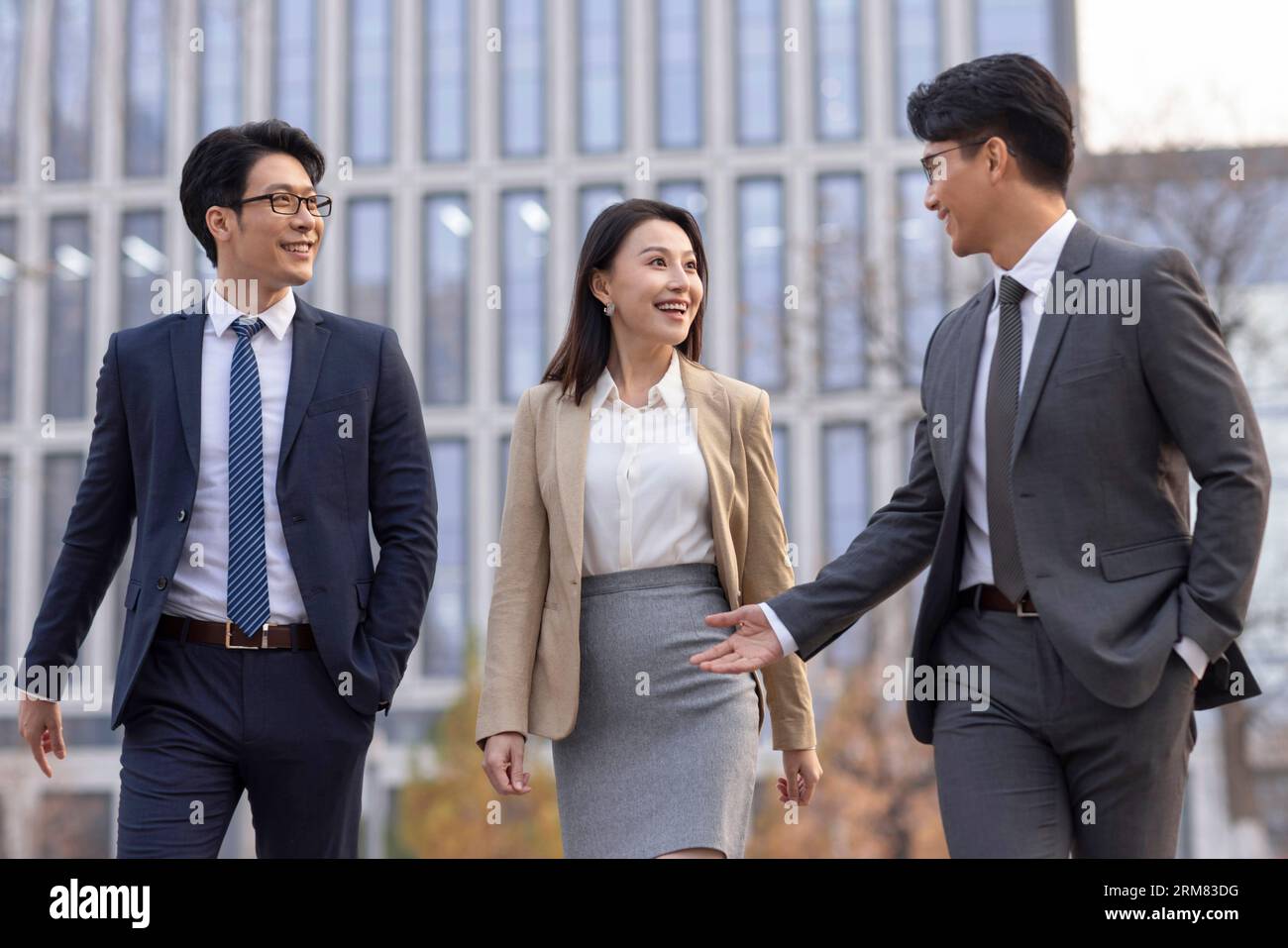 Confident business people walking outdoors Stock Photo - Alamy