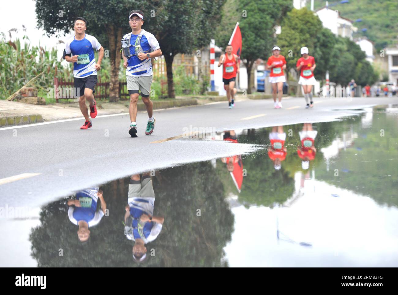 ANSHUN, CHINA - AUGUST 27, 2023 - Runners run in an ancient village in ...