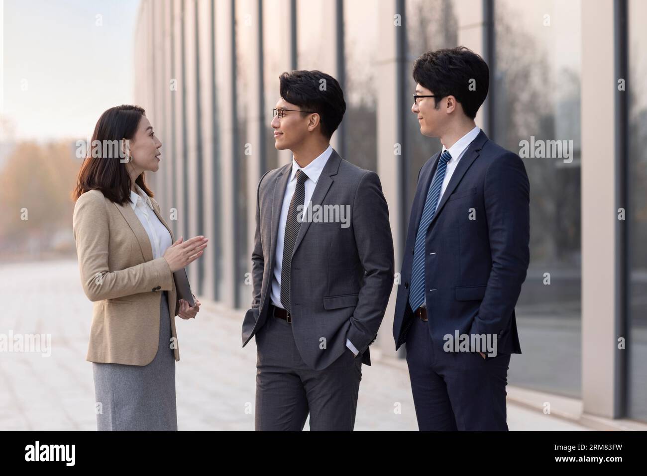 Business people talking outdoors Stock Photo - Alamy