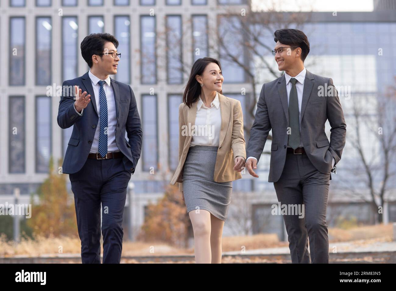 Confident business people walking outdoors Stock Photo - Alamy