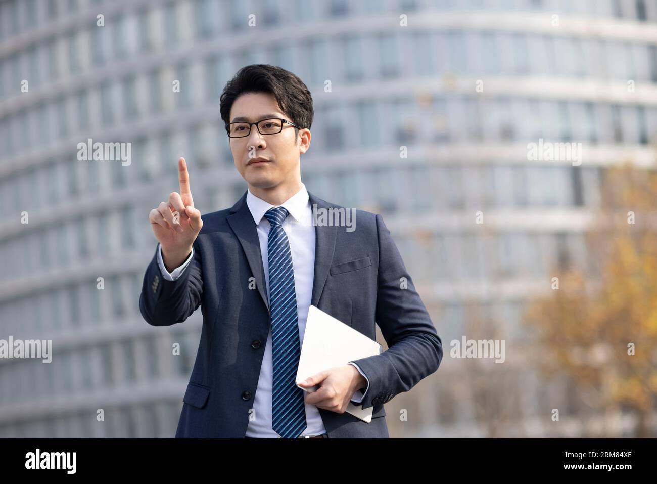 Confident businessman using finger to point Stock Photo - Alamy