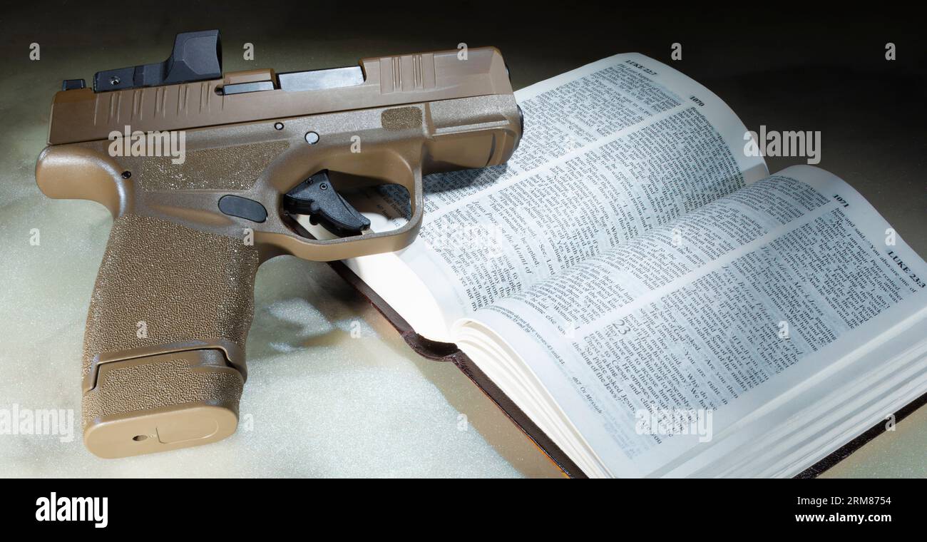 Pistol atop a bible that is open to the page telling Jesus' disciples ...