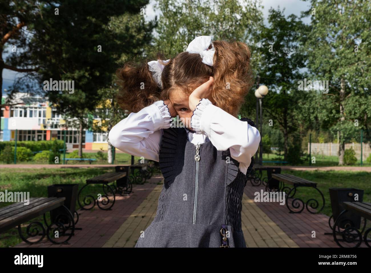 Girl with a backpack near the school after classes, unhappy, tired and ...