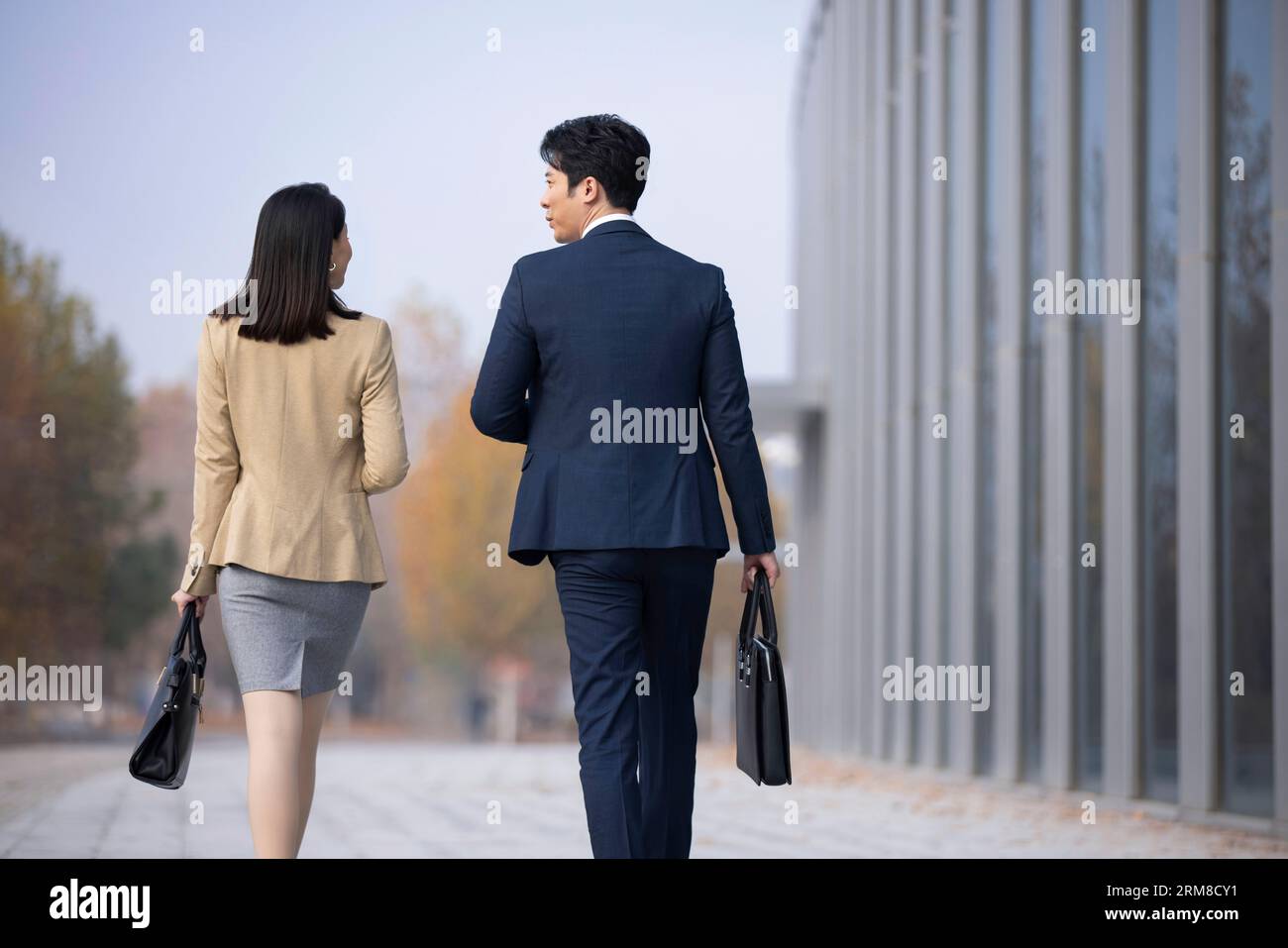 Confident business people walking outdoors Stock Photo - Alamy